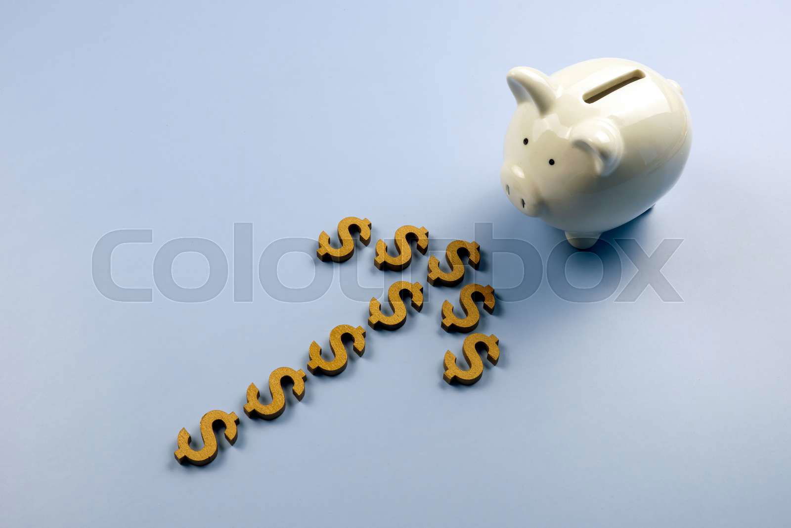 Arrow made of dollar signs and a piggy bank. Increasing pers Colourbox